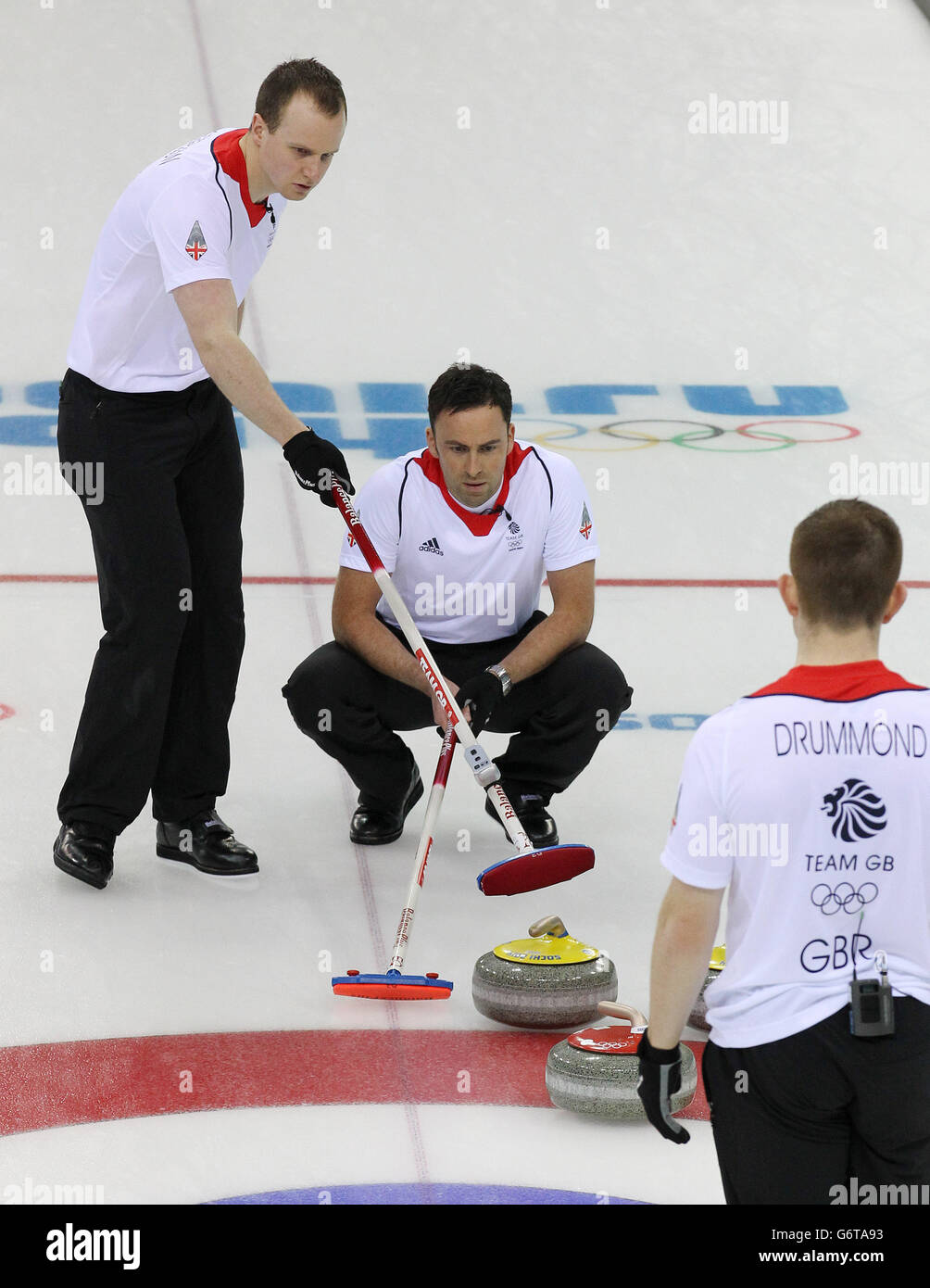 Great Britain's skip David Murdoch (centre) discusses their last shot ...