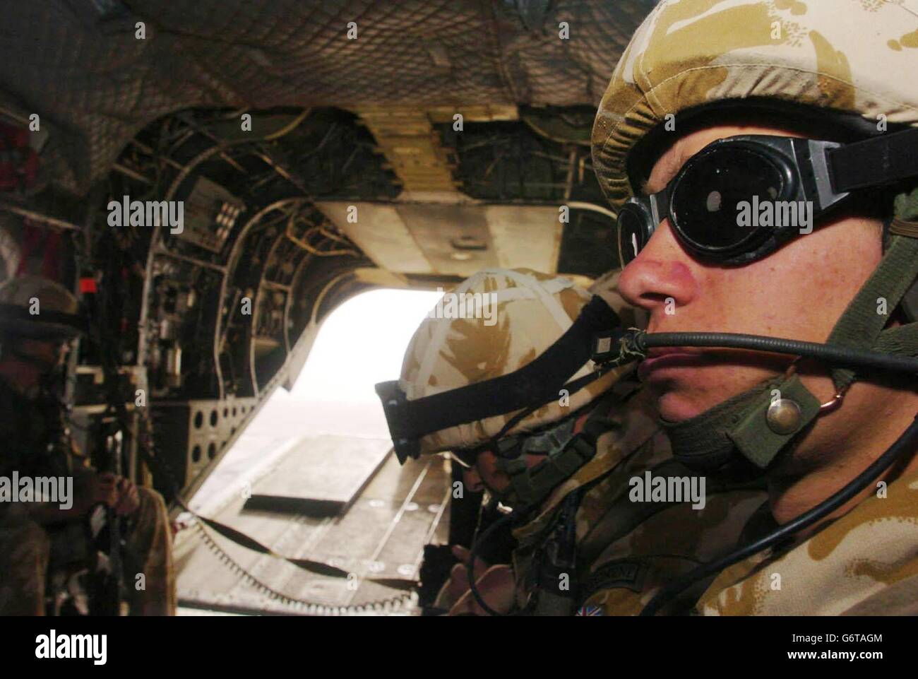 A Gunner from II Squadron RAF Regiment is seated on an RAF Chinook ...