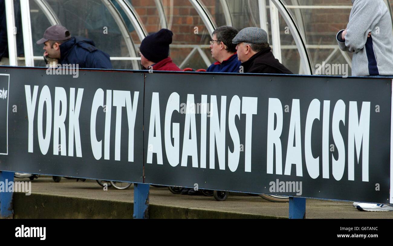 York City supporters look on behind a anti racism hoarding during the ...