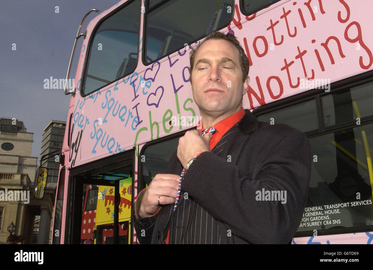 Fashion designer Toby Mott poses for photographers in a London bus ...