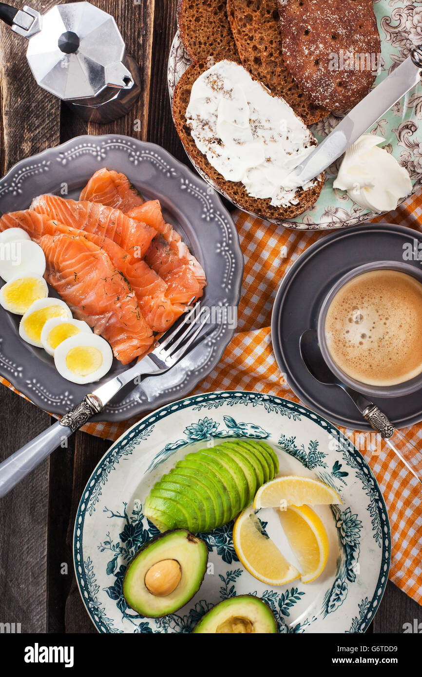 Breakfast with salted salmon, boiled eggs, avocado, bread, cream cheese ...
