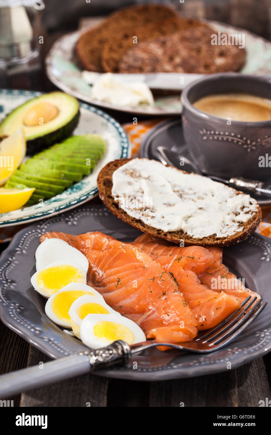 Breakfast with salted salmon, boiled eggs, avocado, bread, cream cheese ...