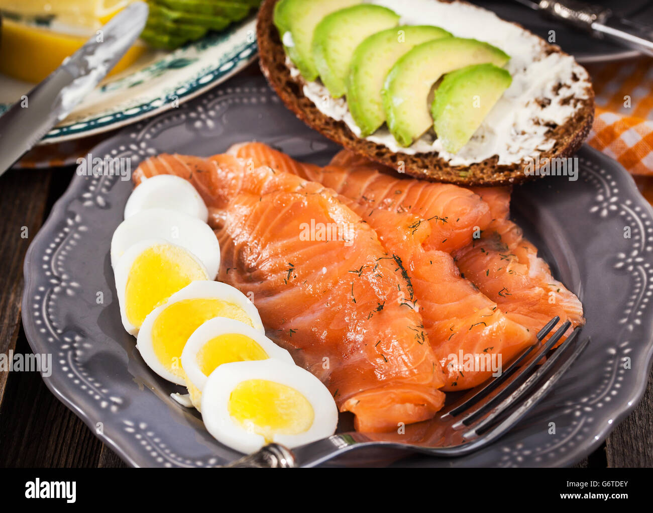 Breakfast with salted salmon, boiled eggs, avocado, bread, cream cheese ...