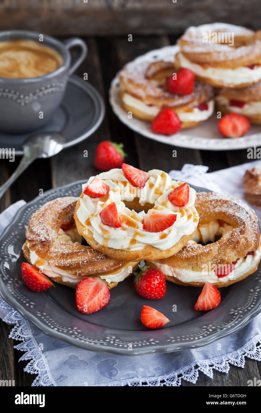 Cream puff rings (choux pastry) decorated with fresh strawberry and ...
