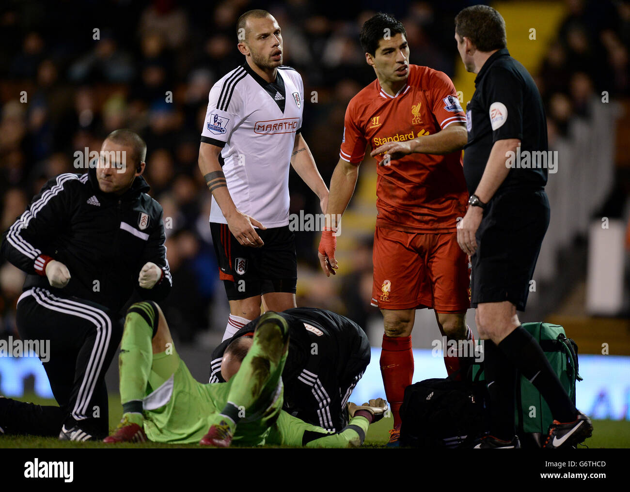 Fulham's Johnny Heitinga (left) and Liverpool's Luis Suarez (centre ...