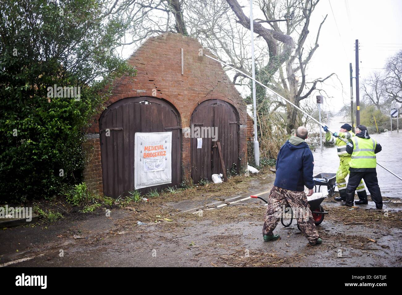 Volunteers try to control a wall which may collapse in Burrowbridge ...