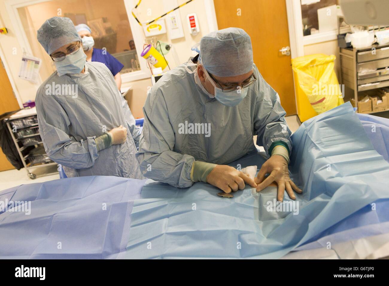 Dr Mike Blackburn, Paediatric Consultant Cardiologist, implants the ...