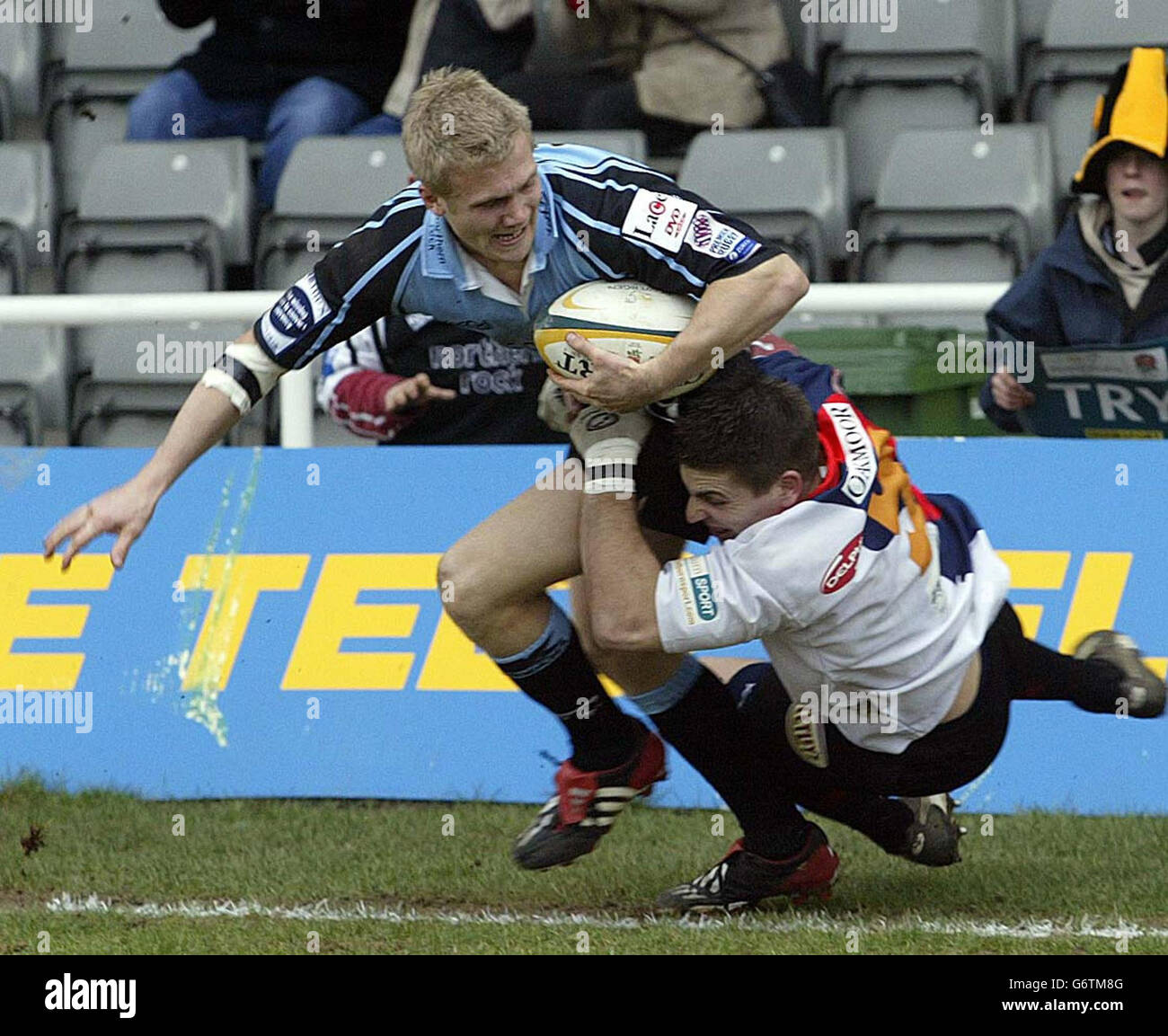 Newcastle Falcons' Michael Stephenson is tackled by Pertemps Bees' Paul ...