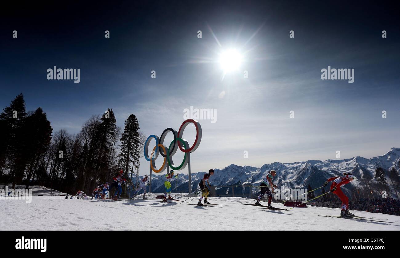 Skiers pass the Olympic rings during the 2014 Sochi Olympic Games in ...