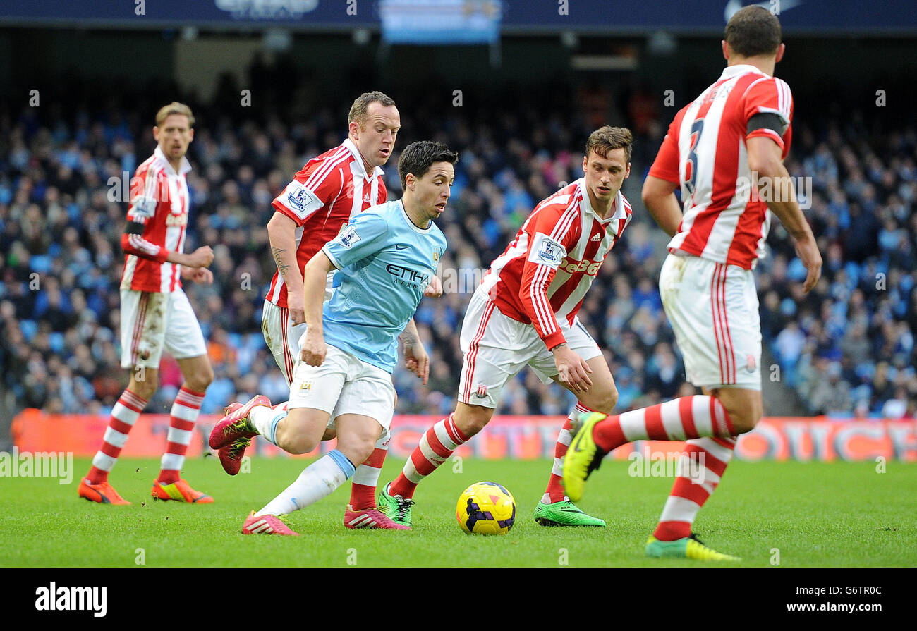 Manchester City's Samir Nasri battles for the ball with Stoke City's ...