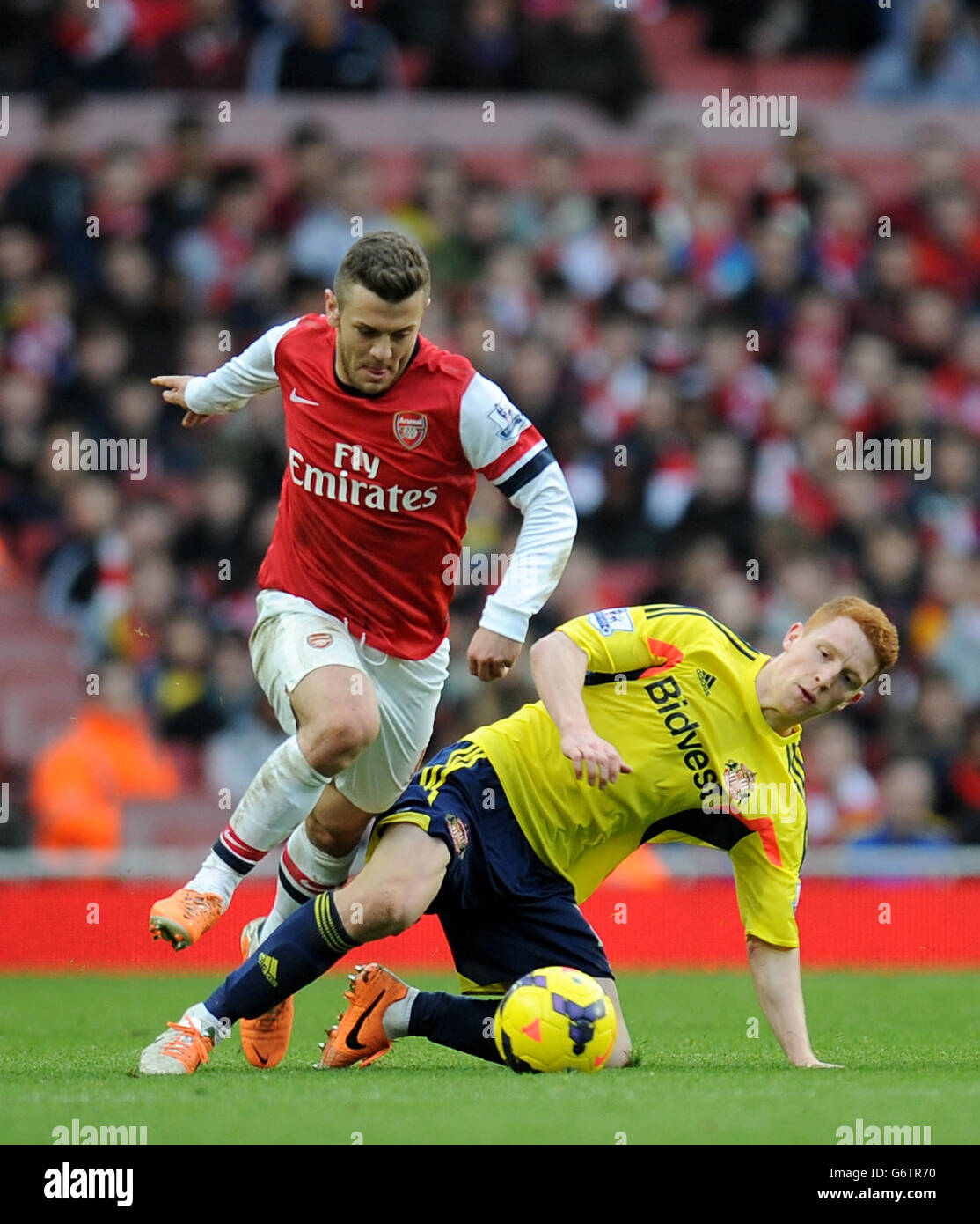 Arsenal's Jack Wilshere (left) skips past a tackled from Sunderland's ...