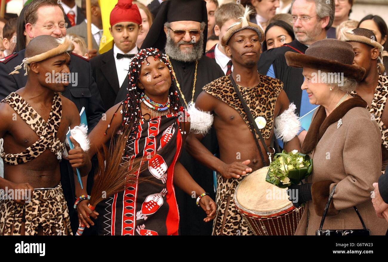 An African dance group play music as Britain's Queen Elizabeth II ...