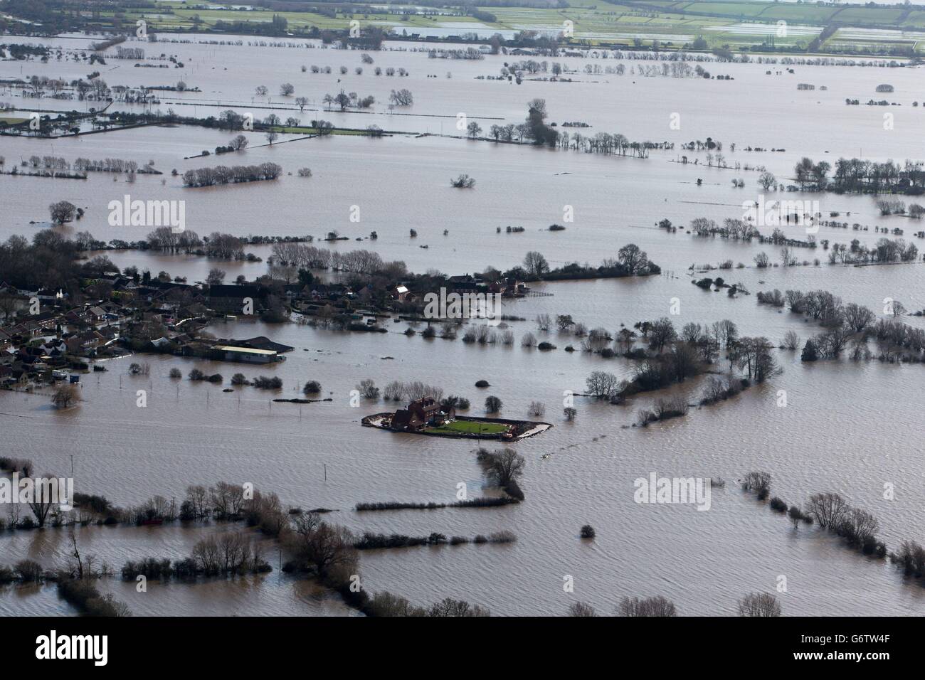 A house (right) near flooded village of Moorland in Somerset which is ...