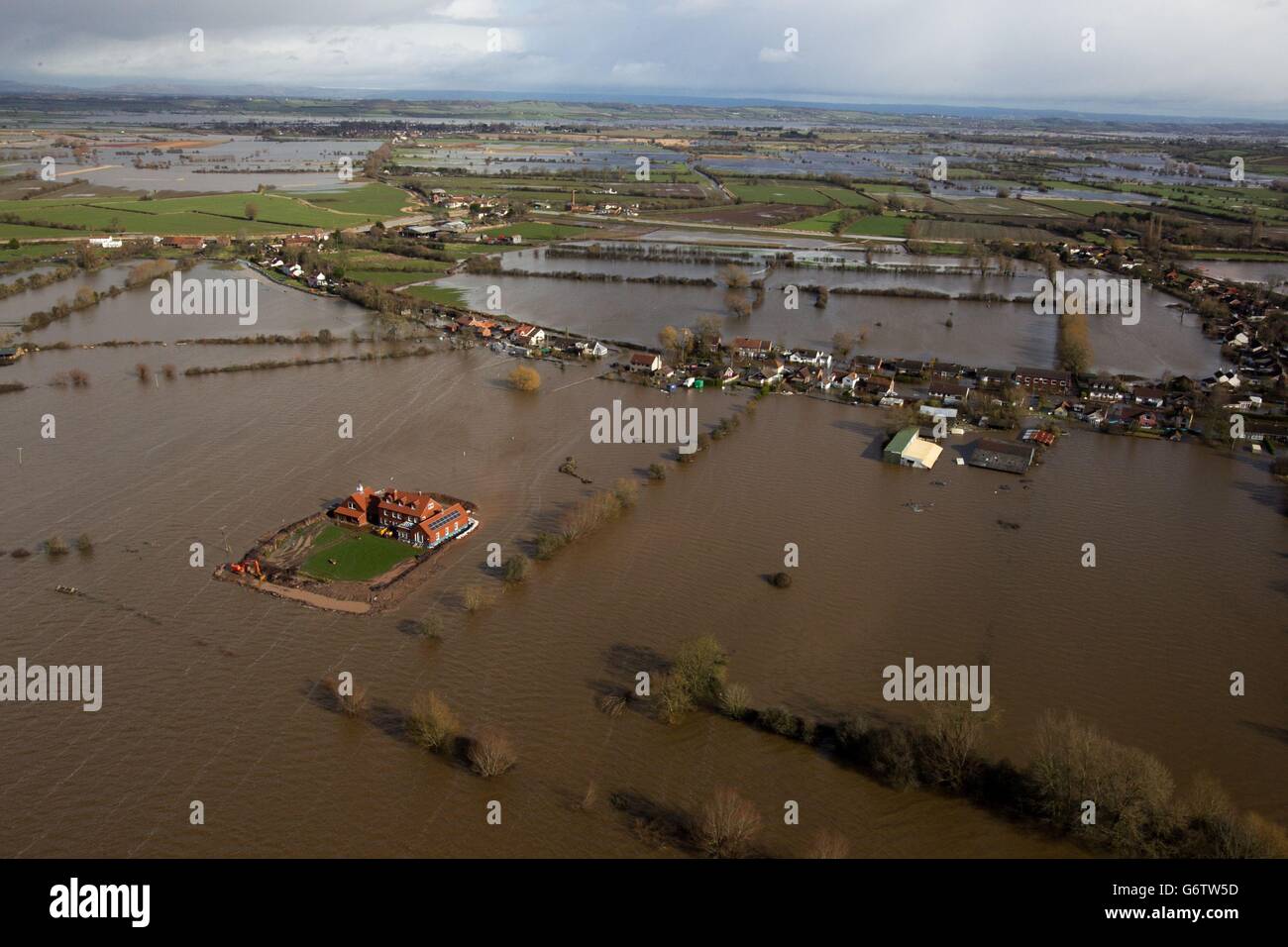 A house (left) near flooded village of Moorland in Somerset which is ...