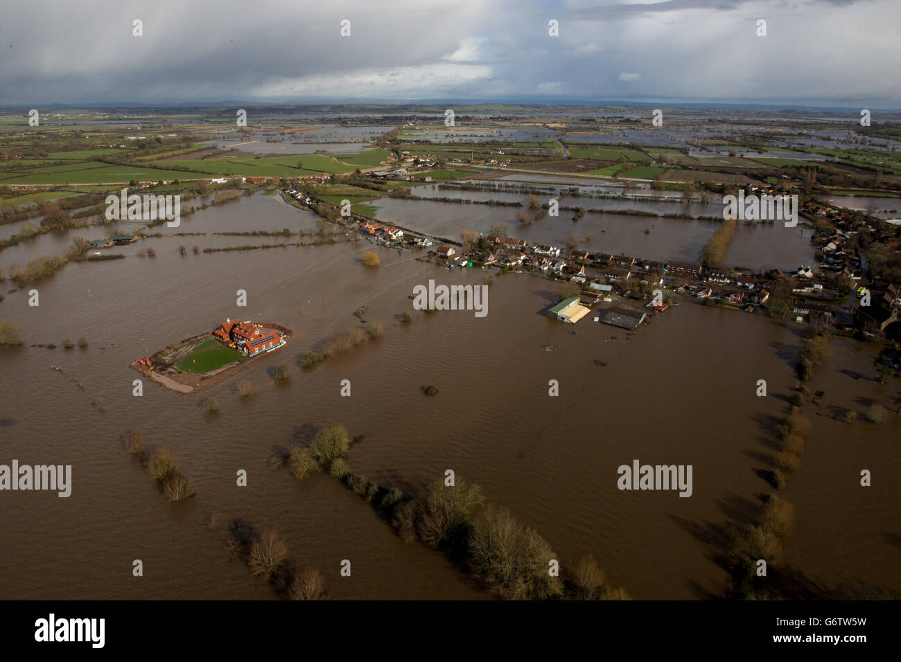 A house (left) near flooded village of Moorland in Somerset which is ...