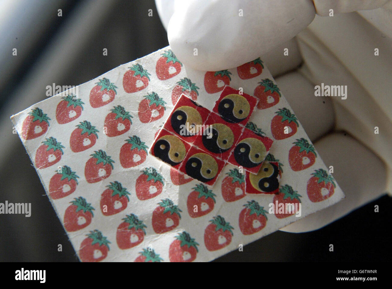 Drugs and drug-taking equipment - a sheet of LSD tabs Stock Photo - Alamy