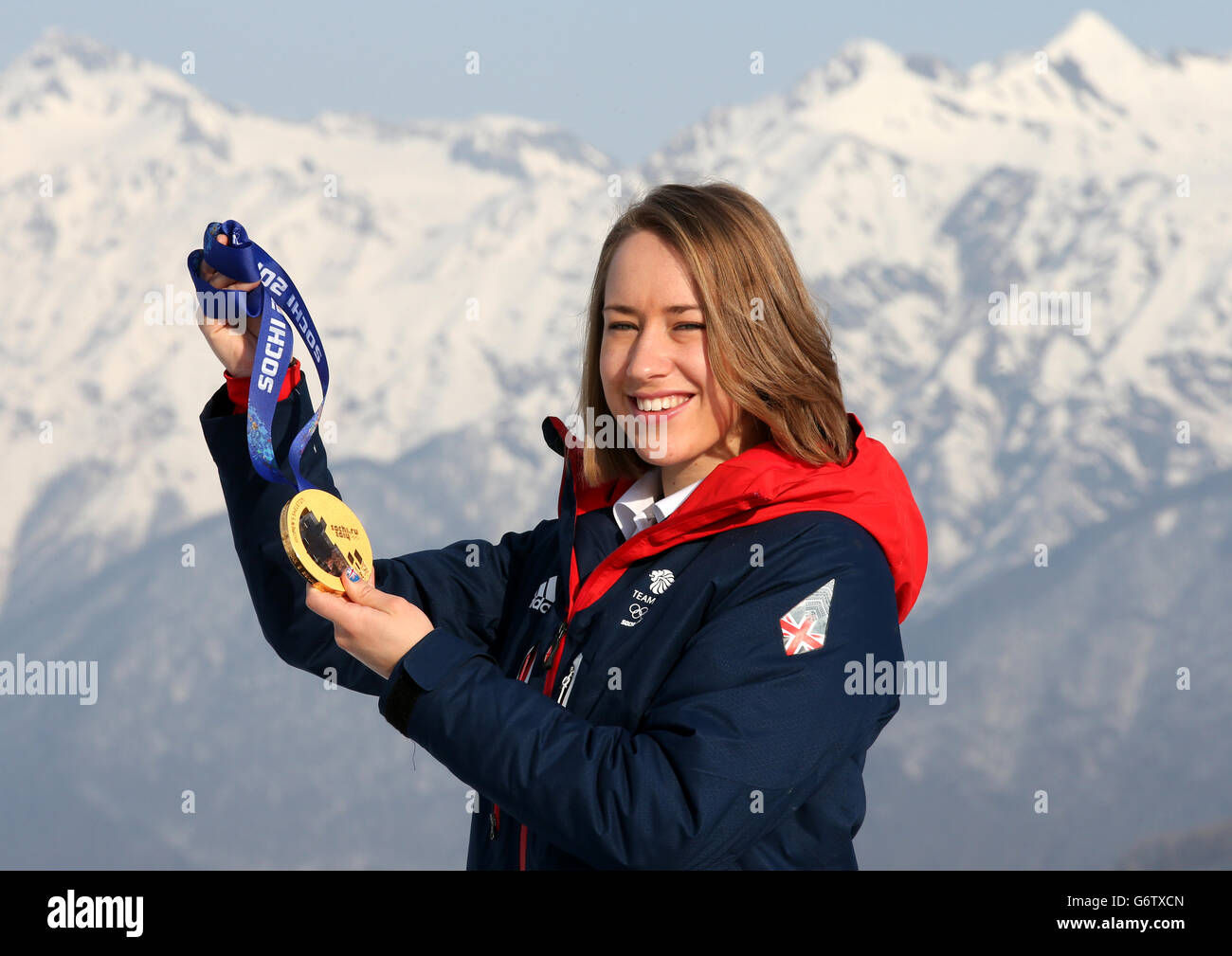 Great Britains Lizzy Yarnold with her gold medal high above the ...