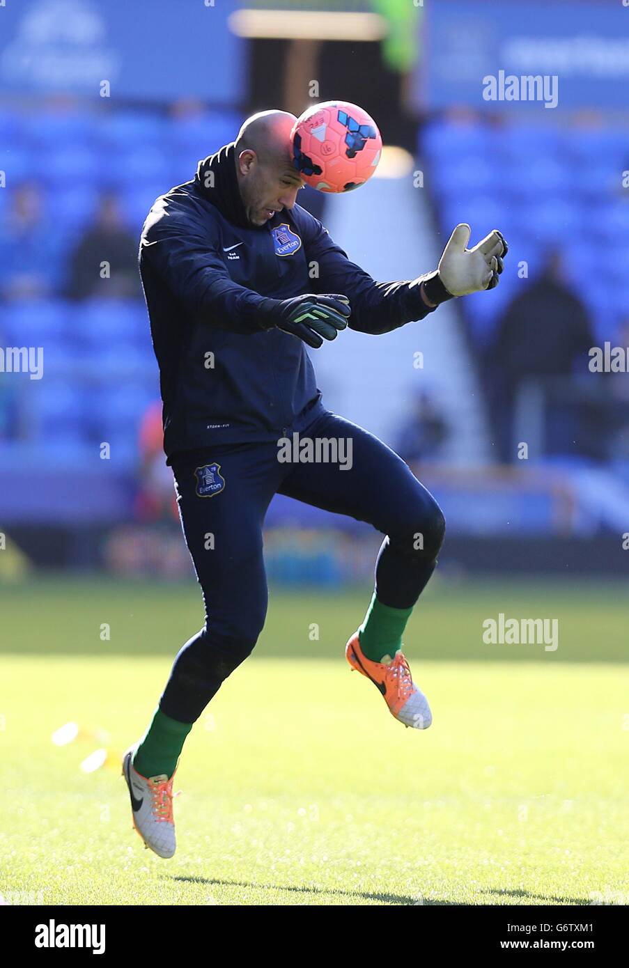 Everton's goalkeeper Tim Howard heads the ball during warm up before ...