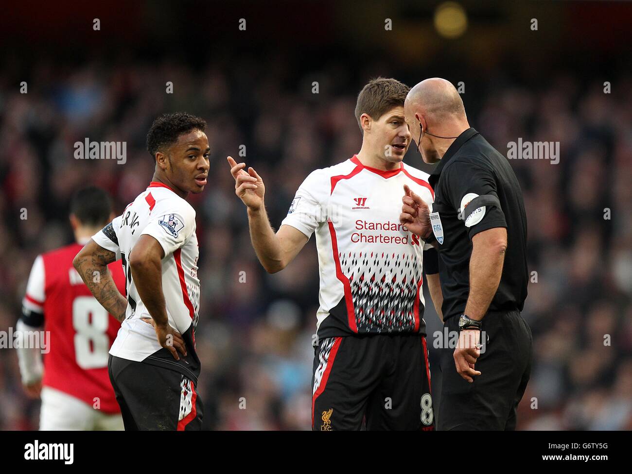 Match referee Howard Webb (right) speaks to Liverpool's Steven Gerrard ...