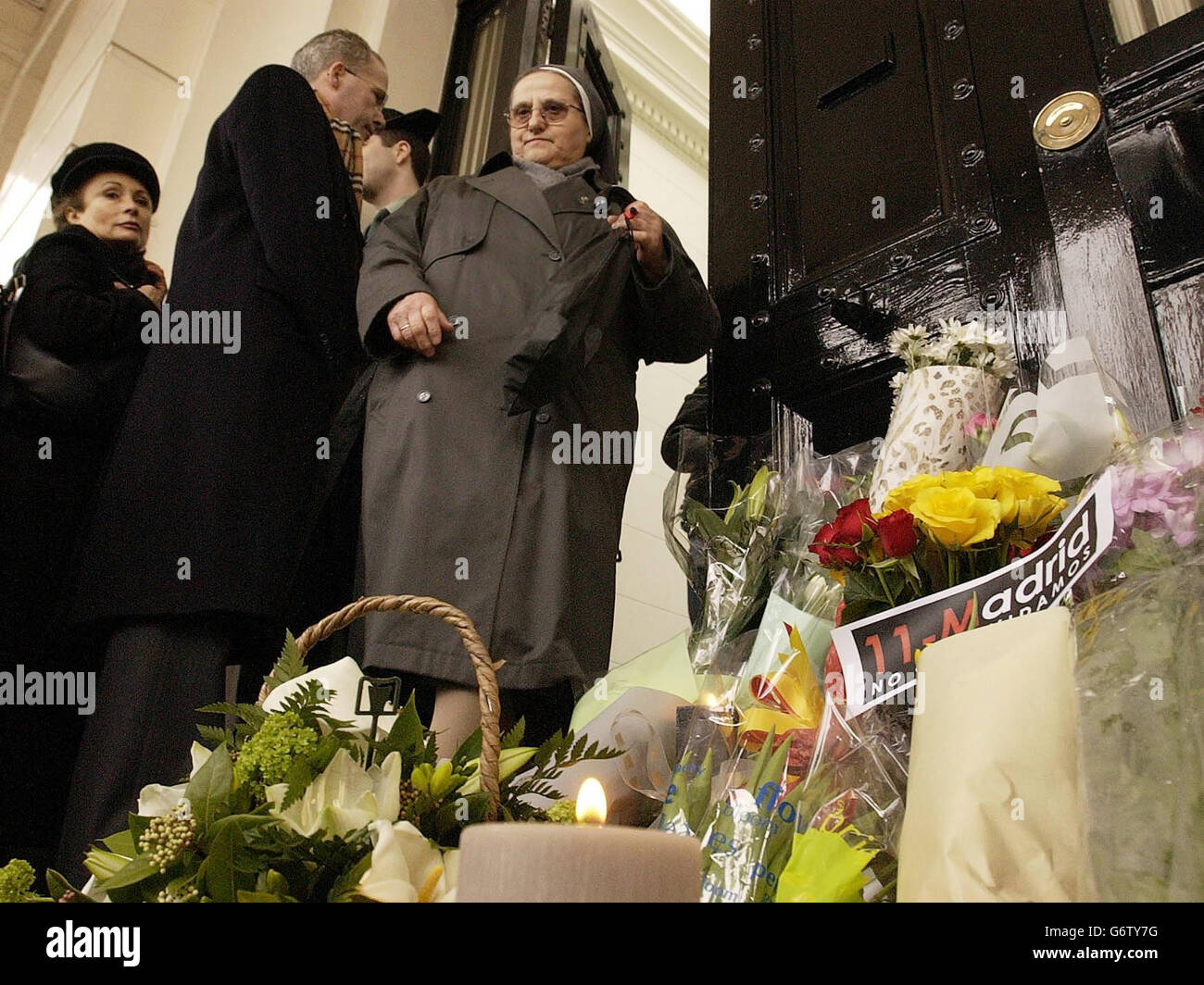 Sister Elena Vazquez of the Addratices passes a floral tribute which ...