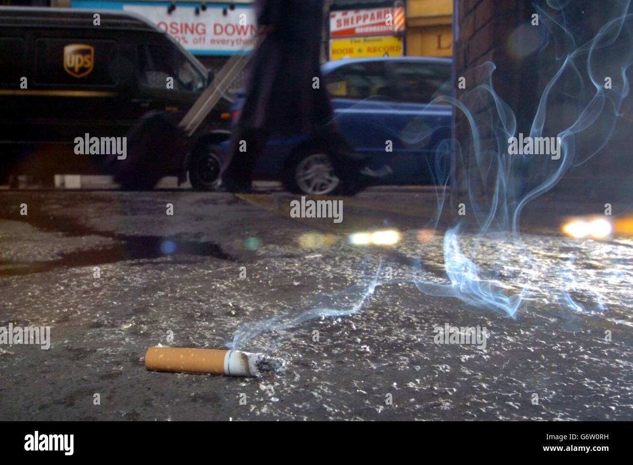 A cigarette on the pavement ban on smoking in the work place Stock ...