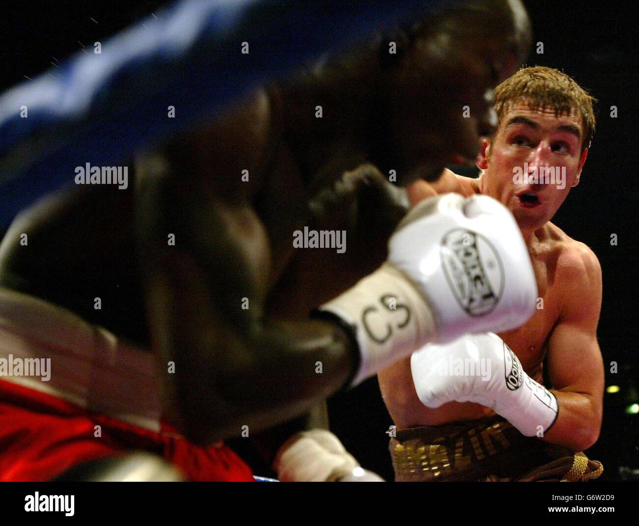 Scotland's Alex Arthur hits Ugandan Michael Kizza (left) during his ...