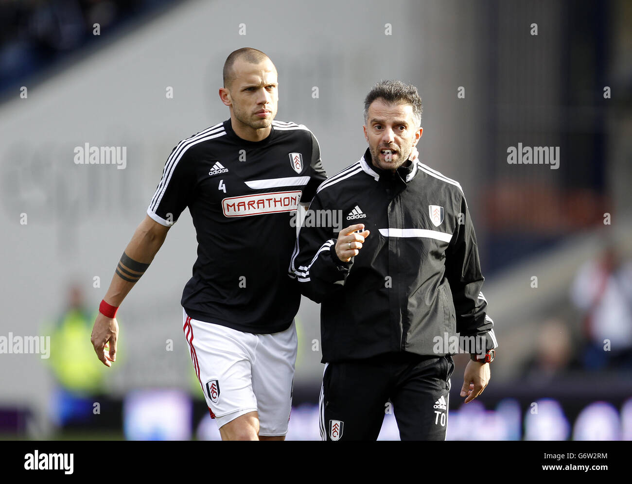 Fulham Assistant coach Tomas Oral (right) speaks with Brede Hangeland ...