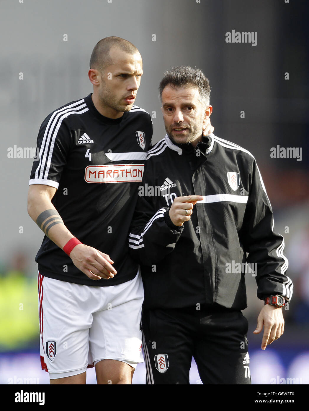 Fulham Assistant coach Tomas Oral (right) speaks with Brede Hangeland ...