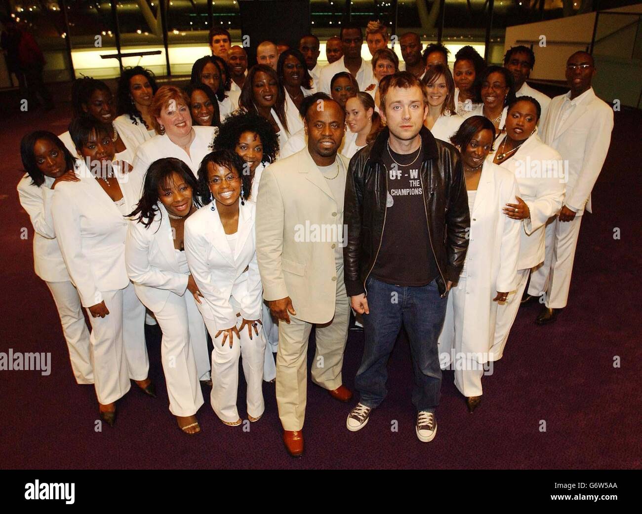 Singer Damon Albarn with Bazil Meade, leader of the choir with members ...