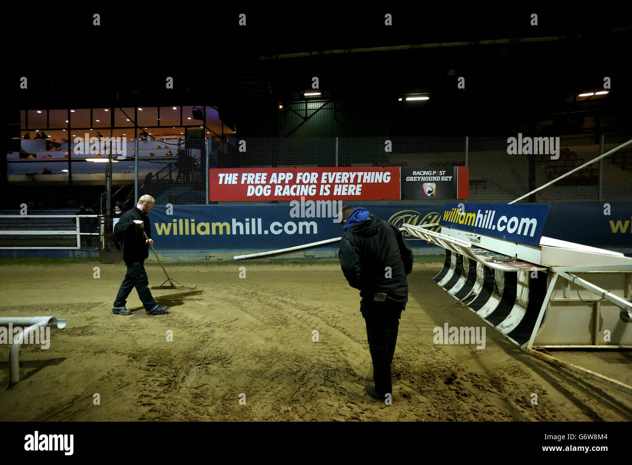 Staff at work on the track at wimbledon stadium hi-res stock ...