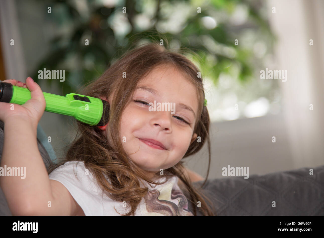 Toddler playing with a flash light Stock Photo - Alamy