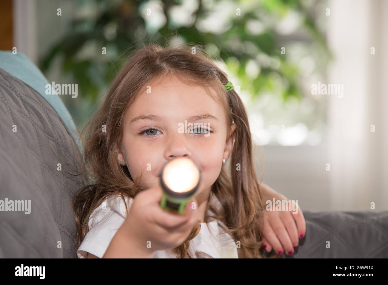 Toddler playing with a flash light Stock Photo - Alamy
