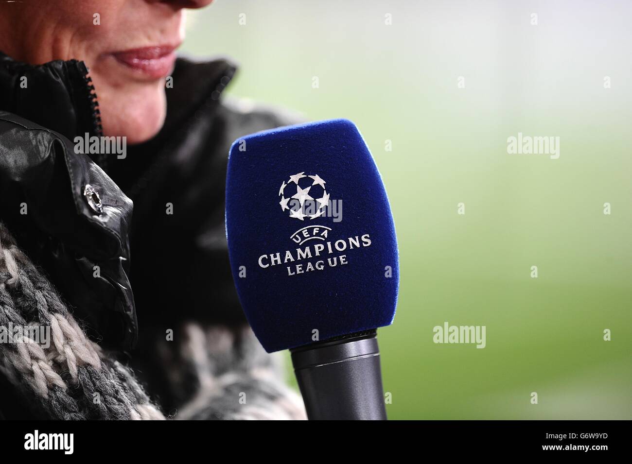 A pichside reporter with a UEFA champions league branded microphone ...