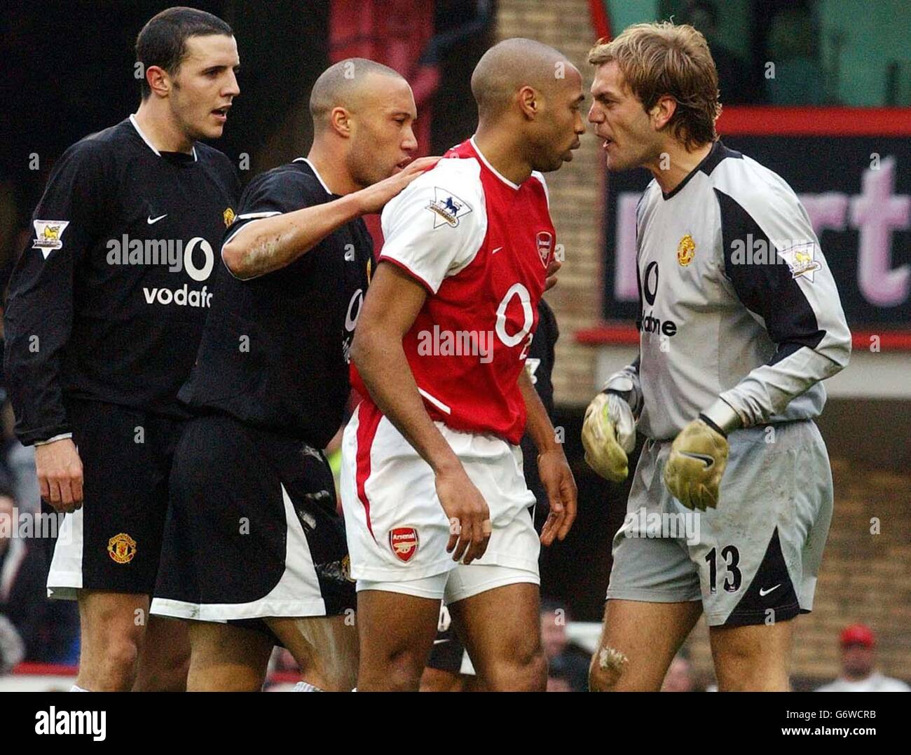 Arsenal's Thierry Henry squares up with Manchester United goalkeeper ...