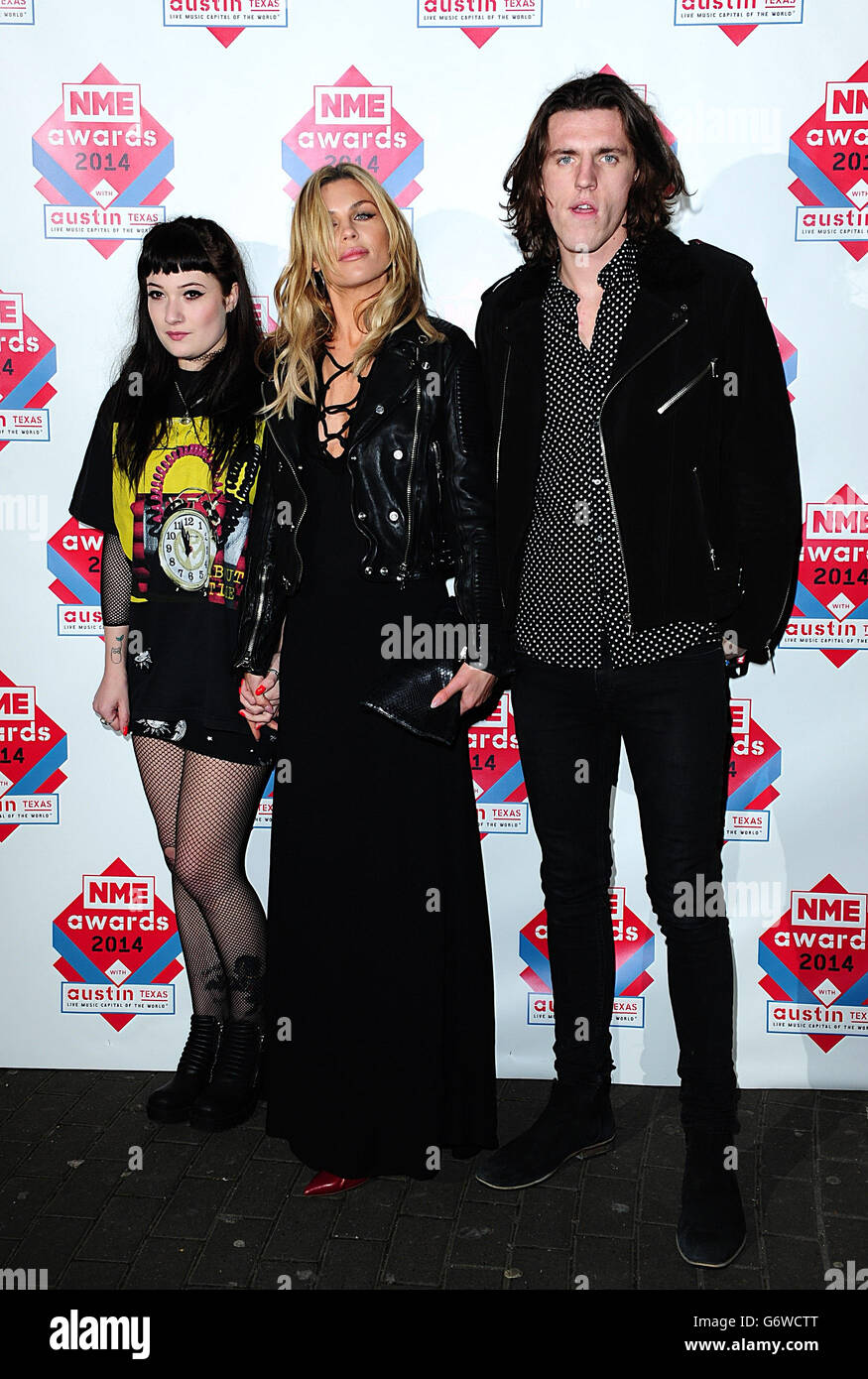 Abbey Clancy (centre) and John Clancy (right) arriving for the 2014 NME Awards, at Brixton ...