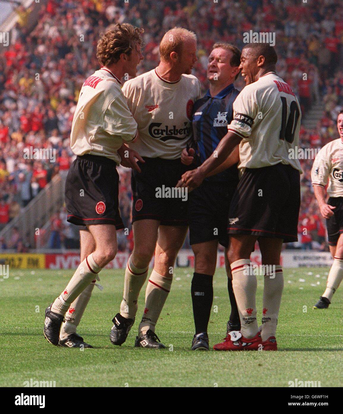 Liverpool players surround the referee after he awarded a penalty to ...