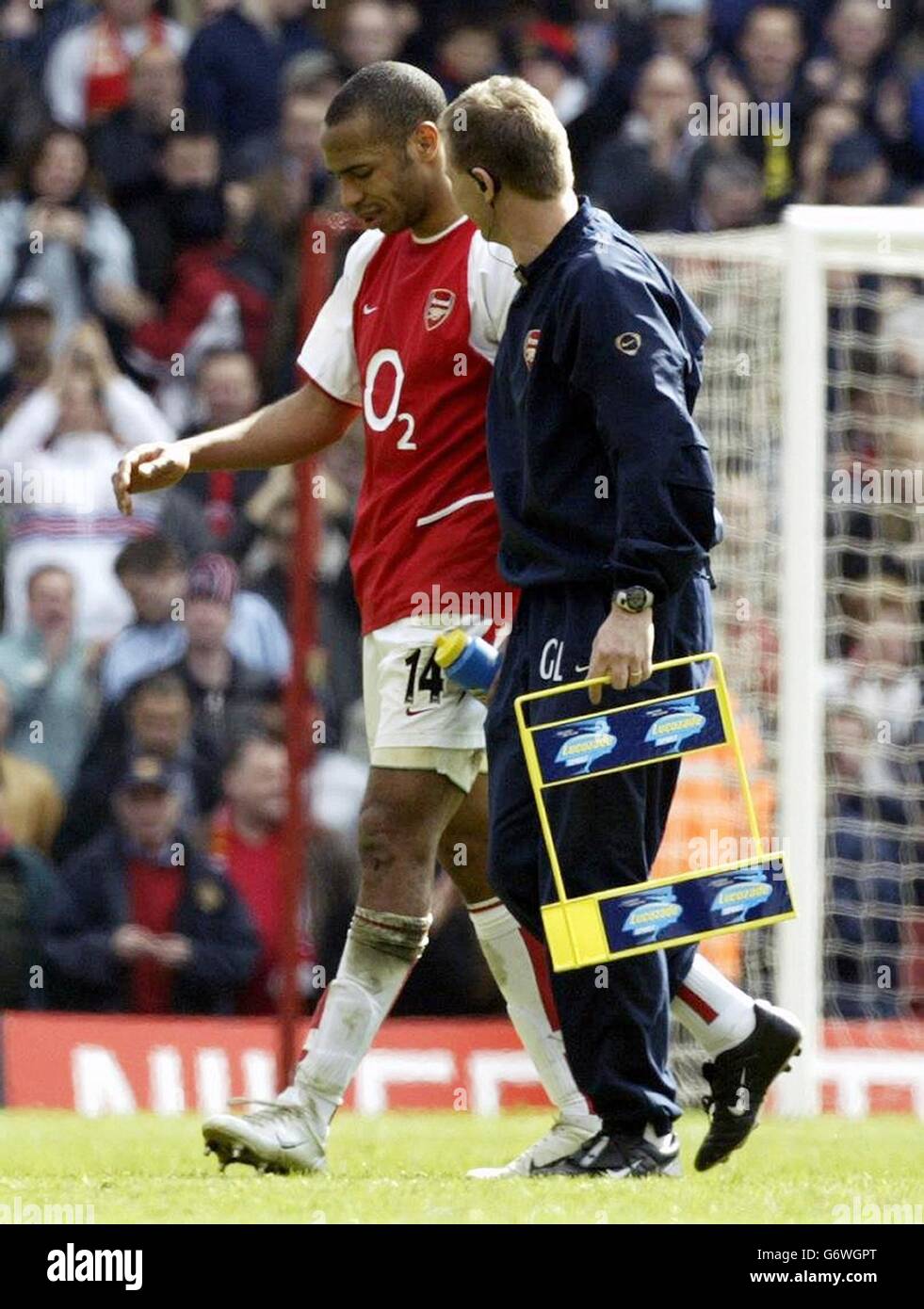 Arsenal's Thierry Henry, talking with Arsenal physio Gary Lewin, walks ...