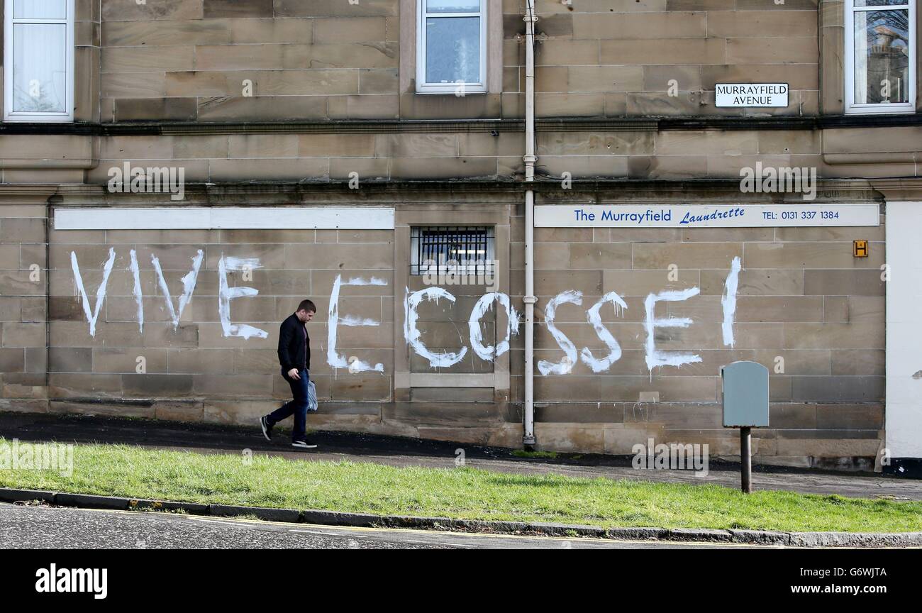 A man walks past graffiti on a wall in Murrayfield Avenue in Edinburgh ...