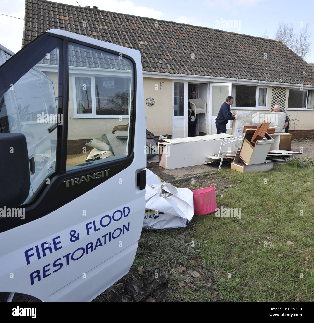 Flood damaged items are removed from a home in the village of Moorland ...