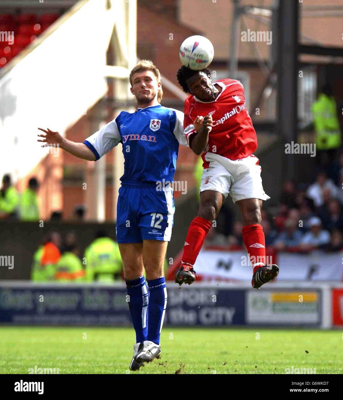 Nottingham Forest's David Johnson (right) beats Millwall's Darren Ward ...