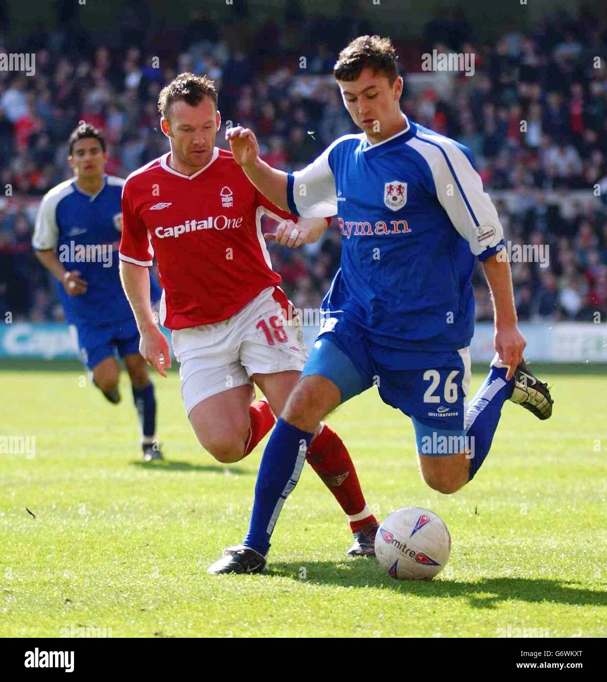 Millwall's Pete Sweeney (right) comes under pressure from Paul Evans of ...