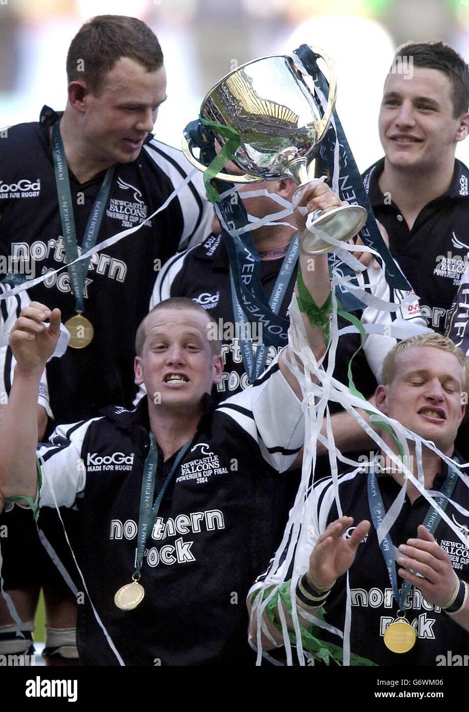 Newcaste's David Walder holds aloft the trophy with the winning try ...