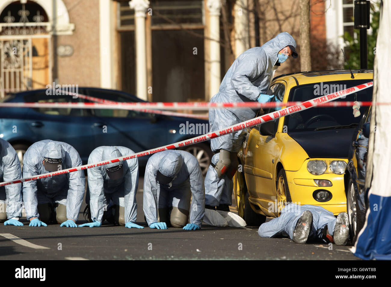 Police forensic officers at the site of a double murder investigation ...