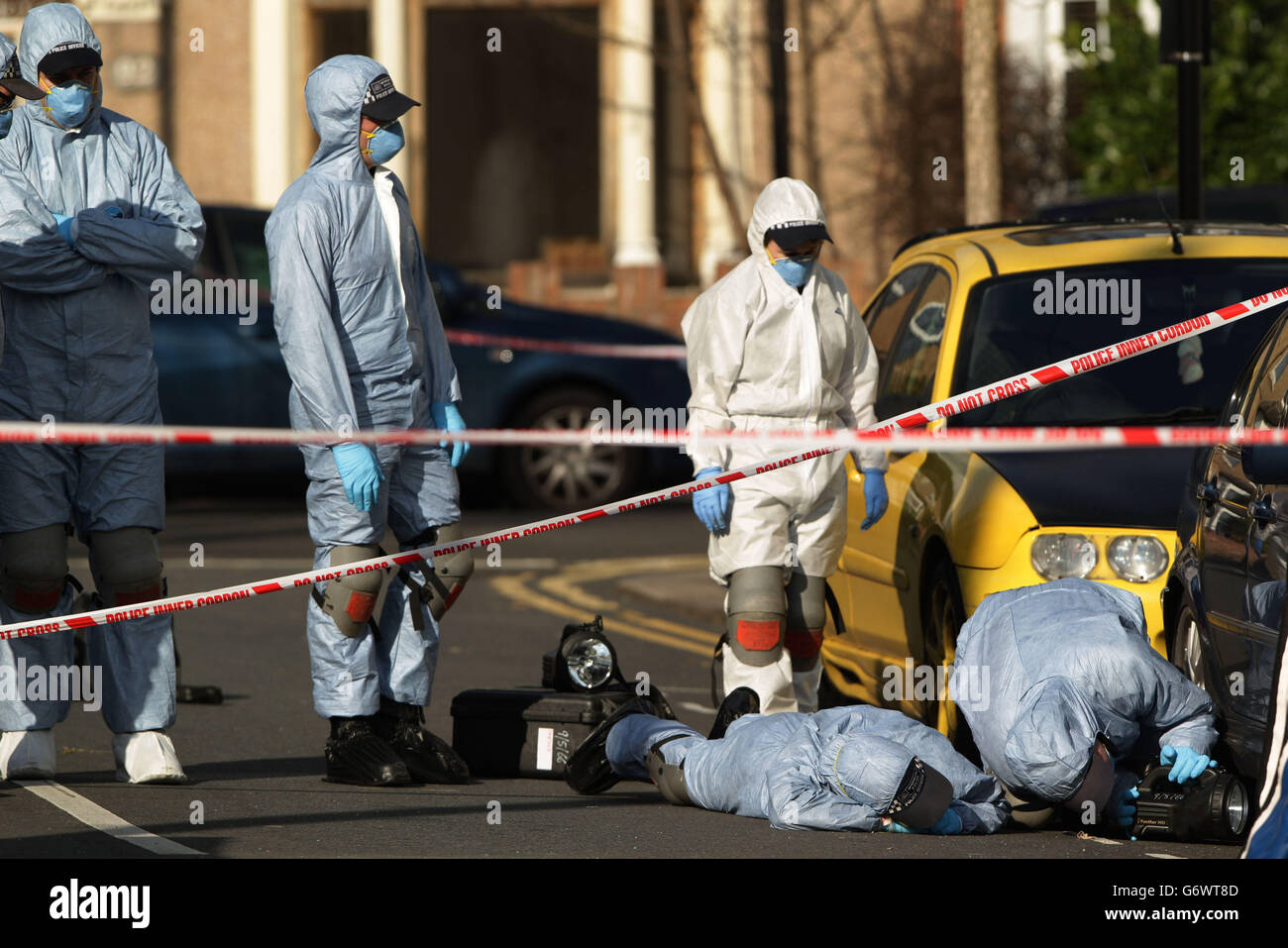 Police forensic officers at the site of a double murder investigation ...