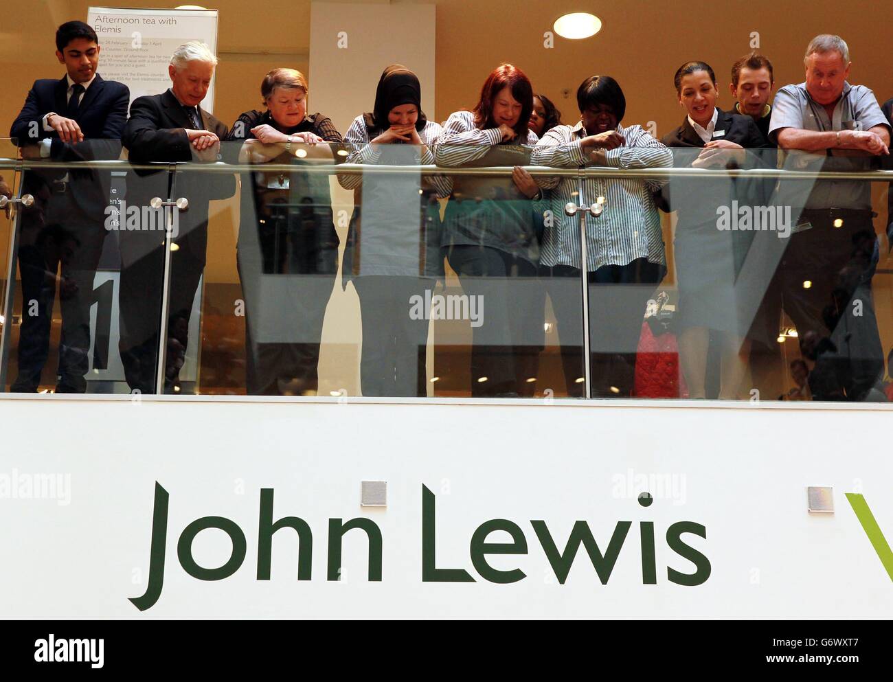 Employees watch as the John Lewis partnership announce their full-year ...