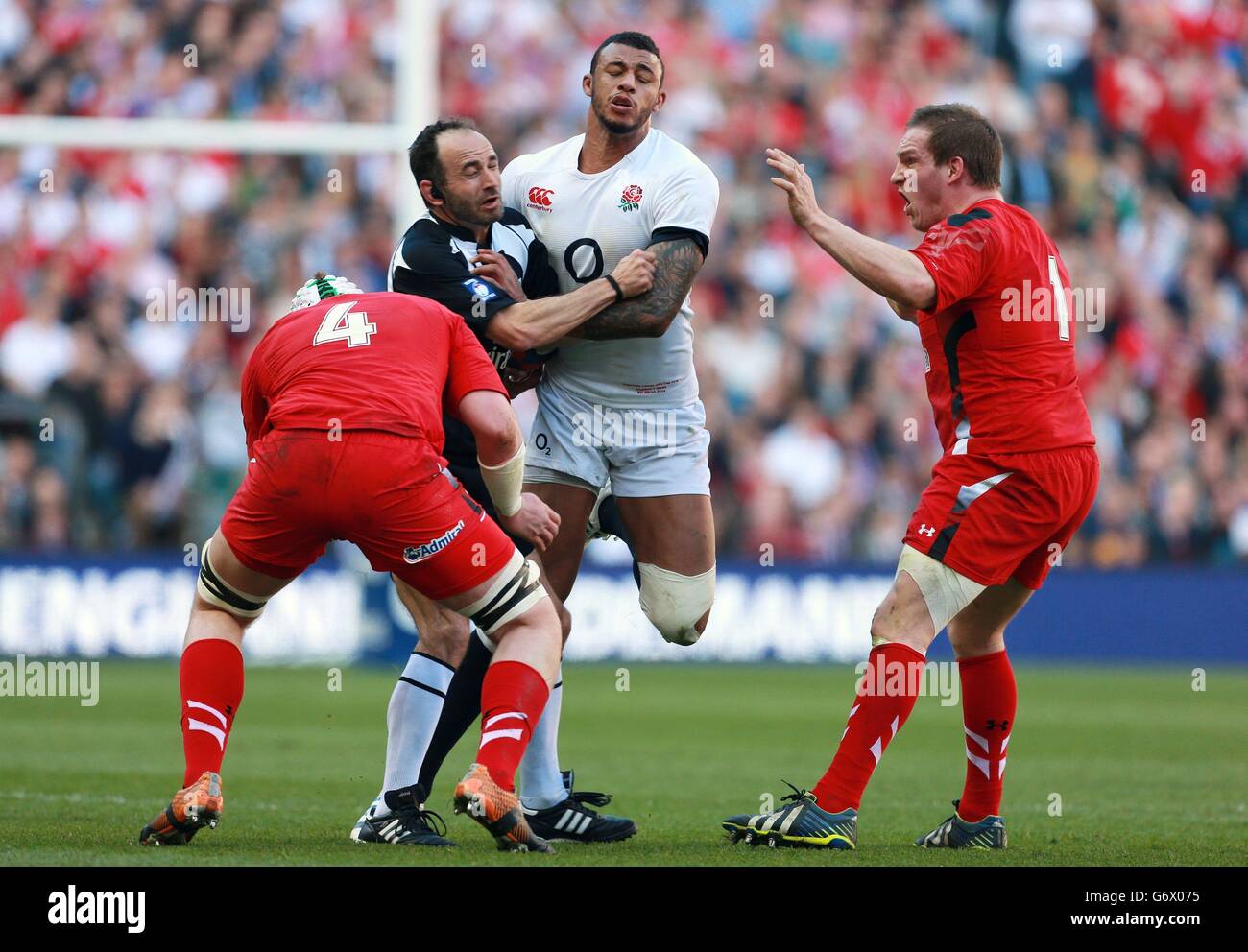 Referee Romain Poite gets caught in a tackle between England's Courtney ...