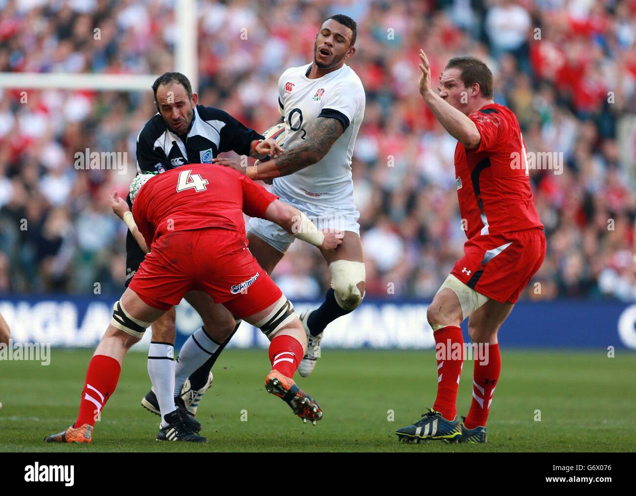 Referee Romain Poite gets caught in a tackle between England's Courtney ...