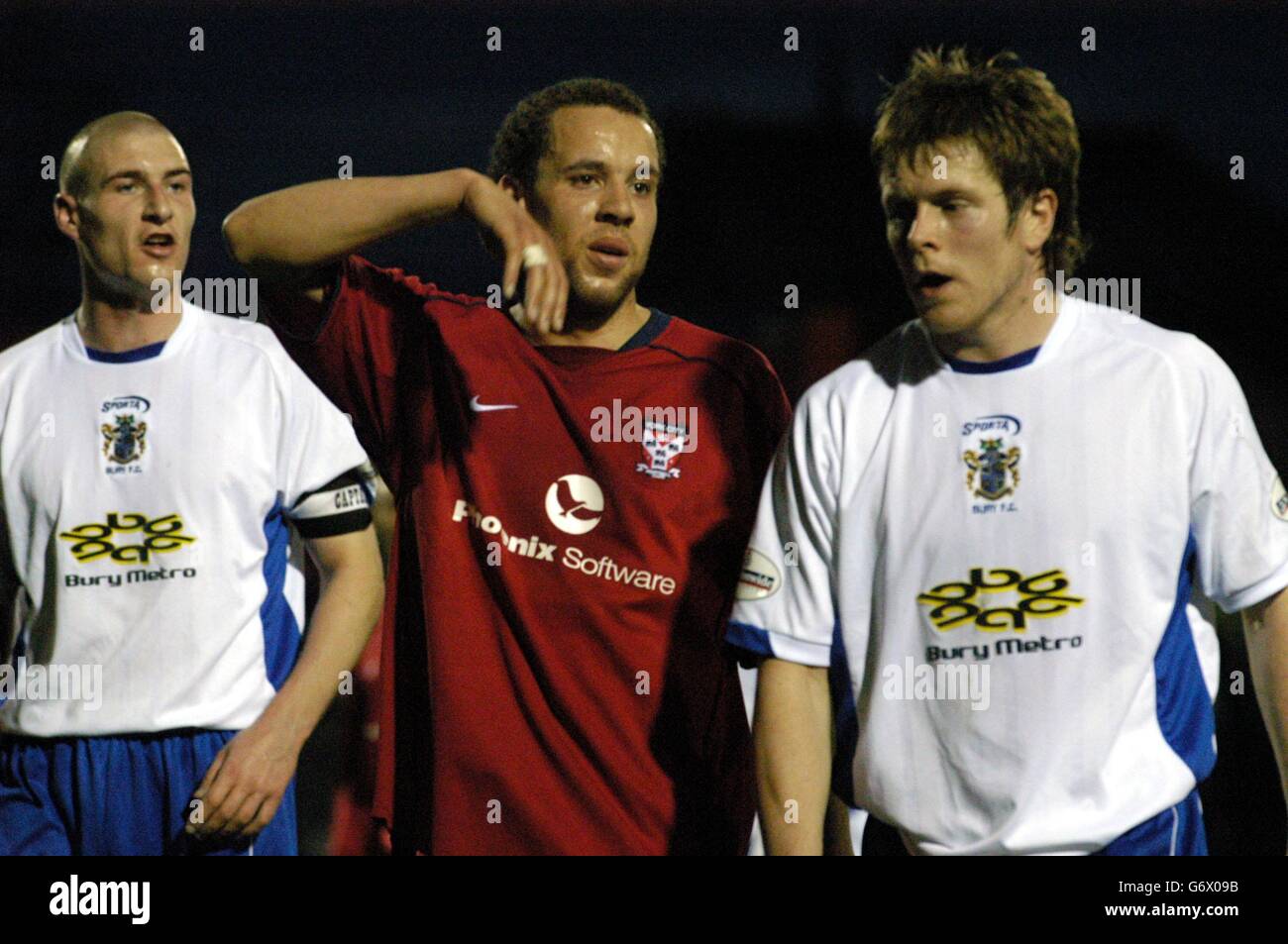 Liam George (centre) in action for York City flanked by Bury captain ...