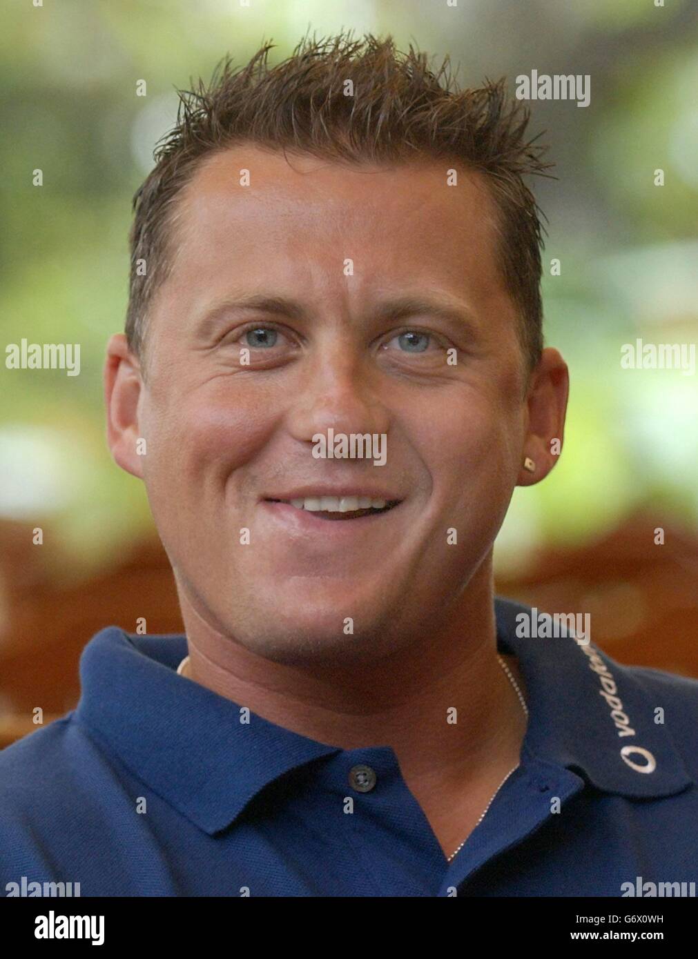 England's Darren Gough shelters from the rain in Guyana, prior to the ...