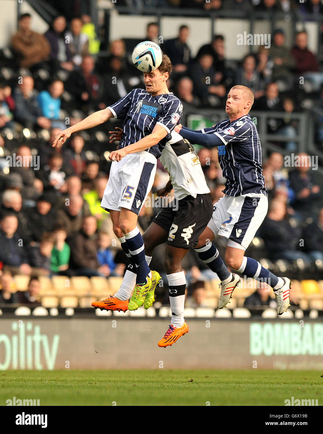Millwall's Edward Upson (left) jumps higher than team-mate Shane Lowry ...